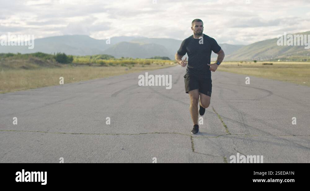 Jogger during intense training in the morning. Runner sprinting during ...