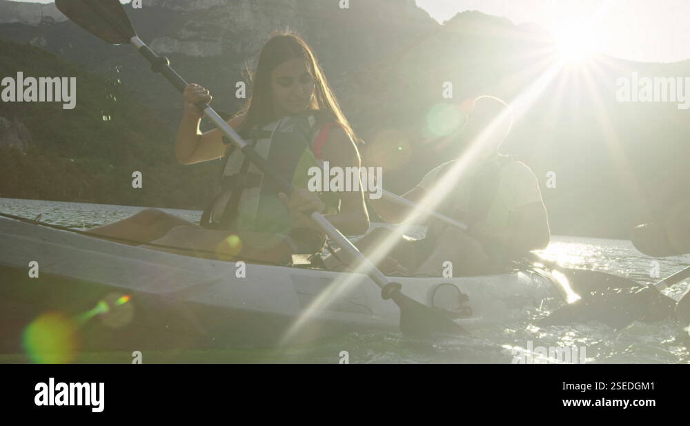 Kayak rowing slow motion. Kayaker woman and man kayaking in a beautiful ...