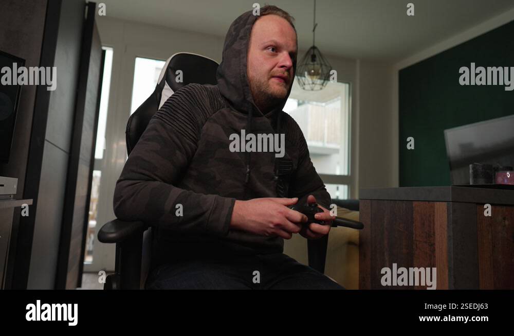 VIDEO GAMES - Man playing Xbox game loses, slow motion medium shot ...