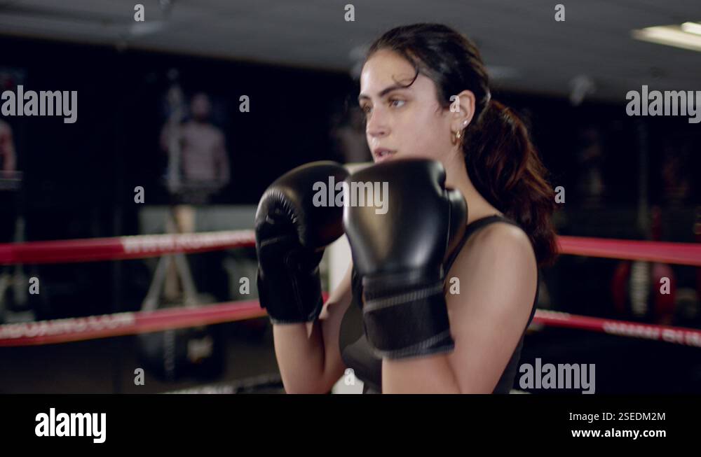 Girl makes punches. Sportive young coach and woman have training in the ...