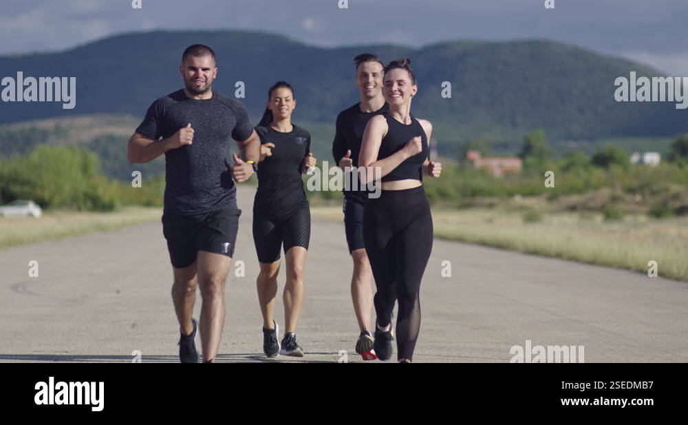 Multiethnic group of athletes running together on a panoramic ...