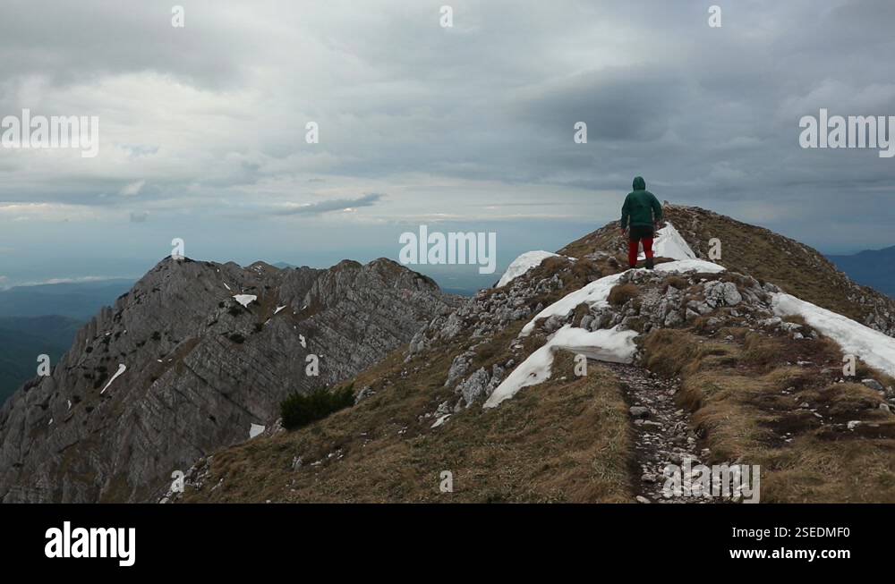 Hiker walking on rocky mountain peaks at high altitude Stock Video ...