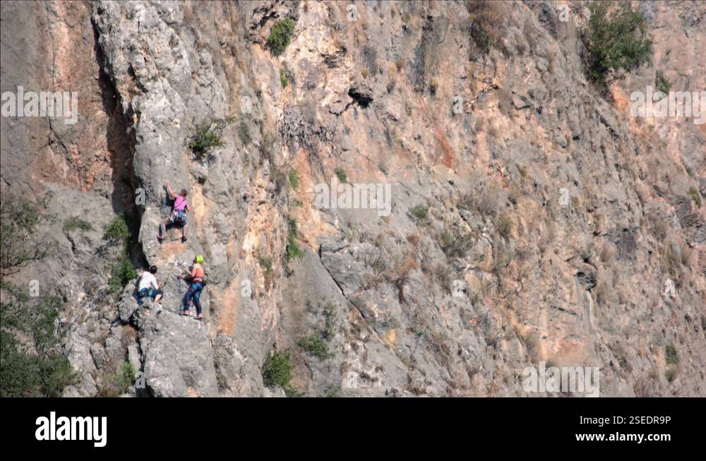 Rock climbers climbing on the cliff. People, mountaineering, adventure ...