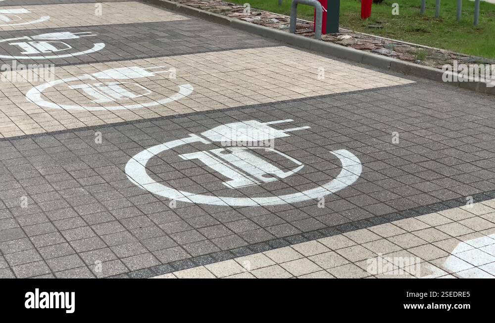 Brand new: Electric car charging lot signs on pavement at parking lot ...