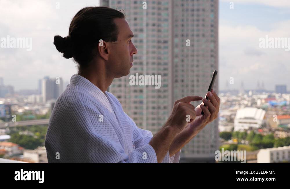 Man slowly look to smartphone, turn head and watch on city, then ...