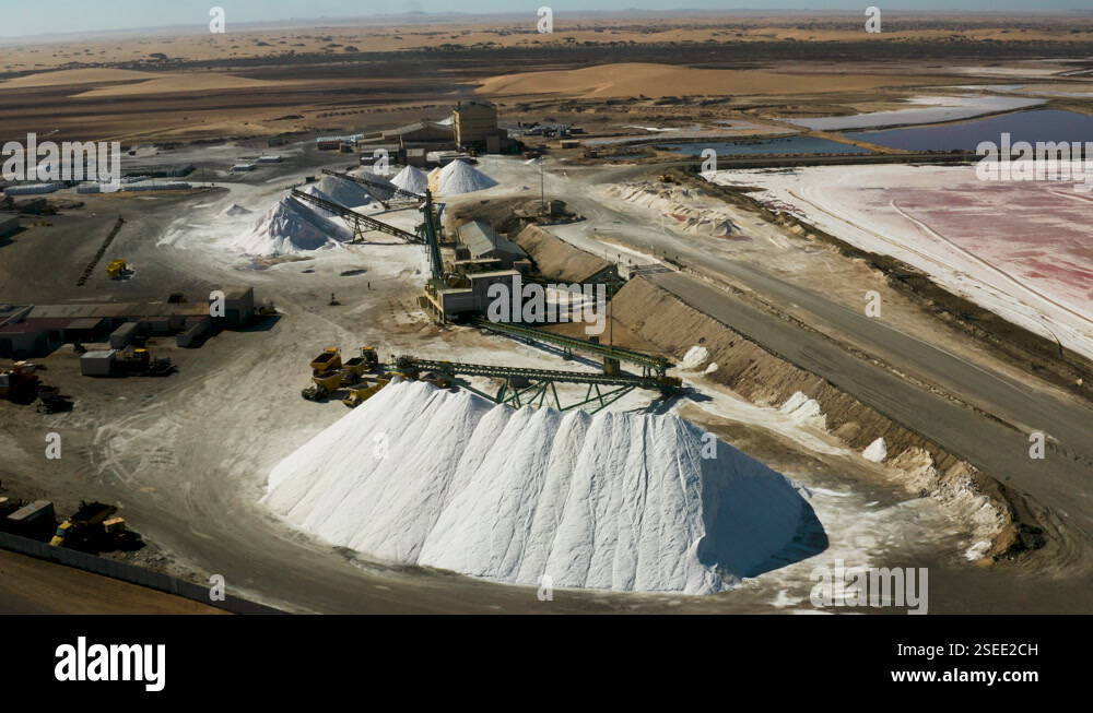 Aerial zoom out view of a sea salt producing factory in Walvis Bay ...