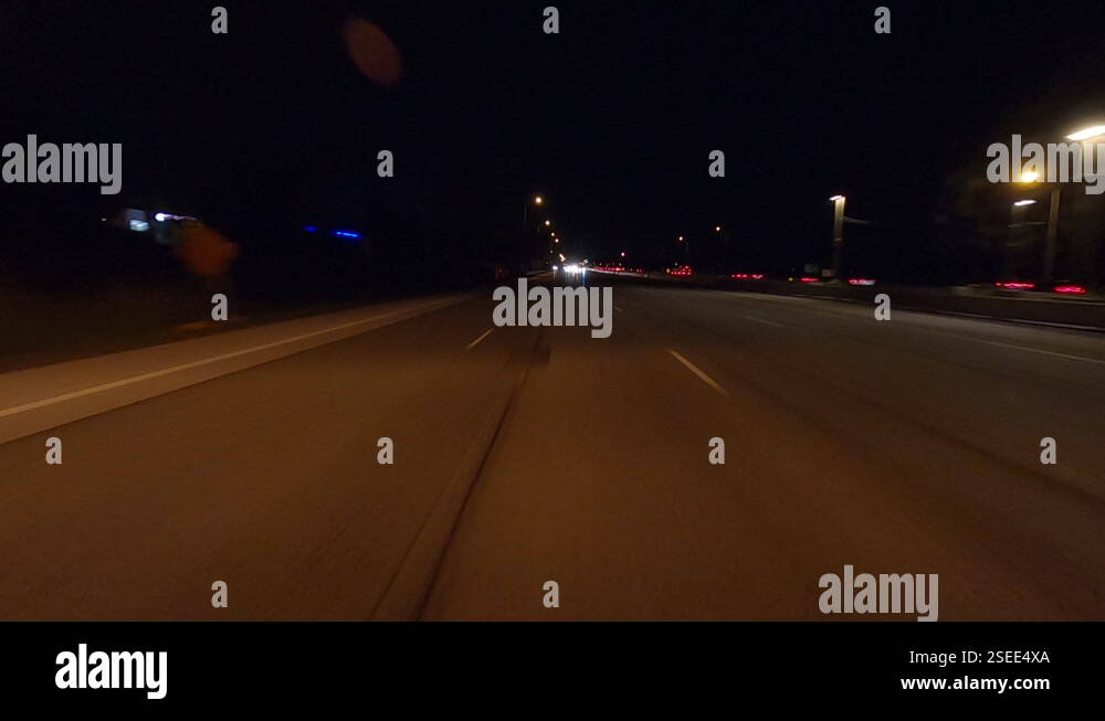 POV driving plate reverse shot roads and highways on a very dark night ...