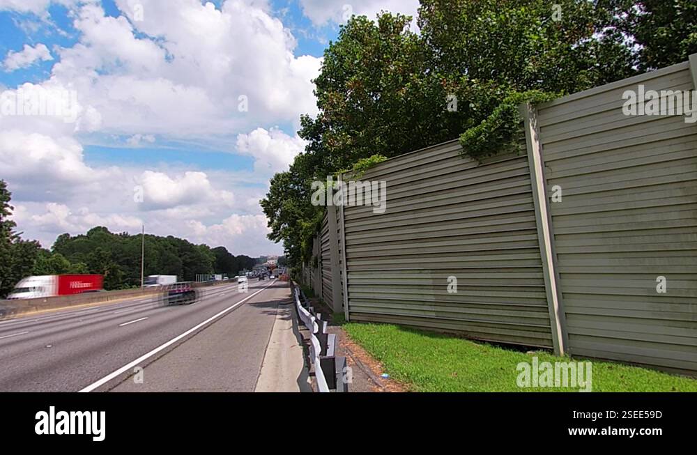Traffic on interstate 285 in medium traffic road side view time-lapse ...