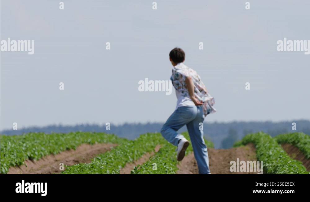 Man run along field potato. Super slow motion of a happy man racing for ...