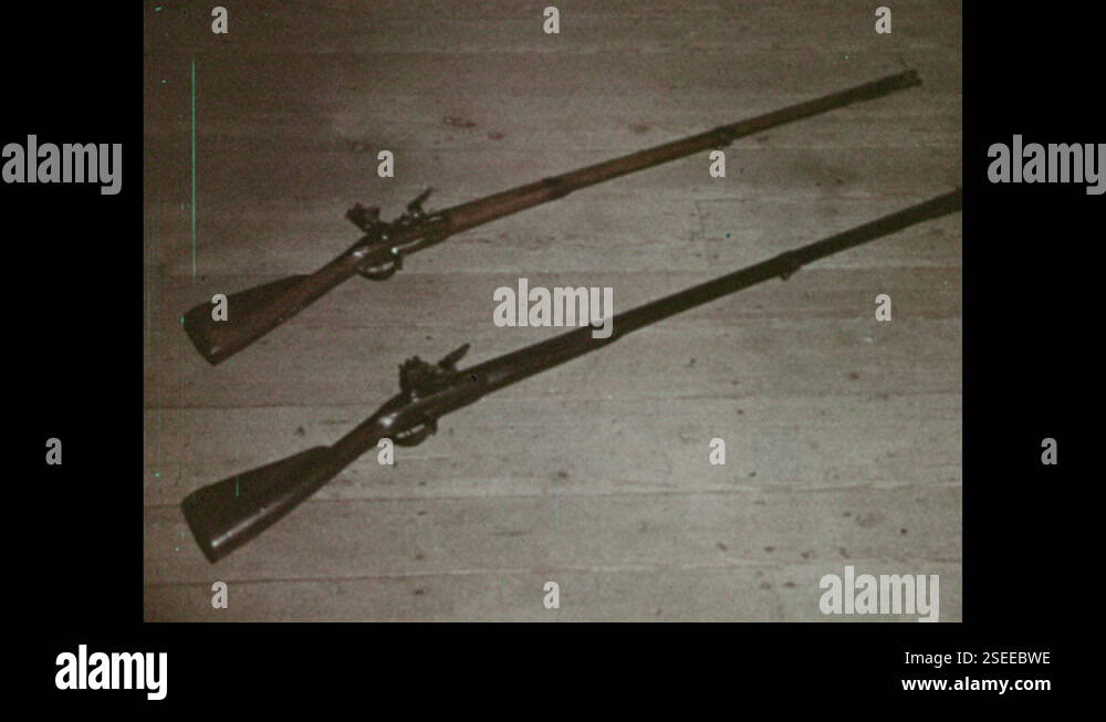 1960s: Flintlock pistols on wooden surface. Flintlock muskets on wooden ...