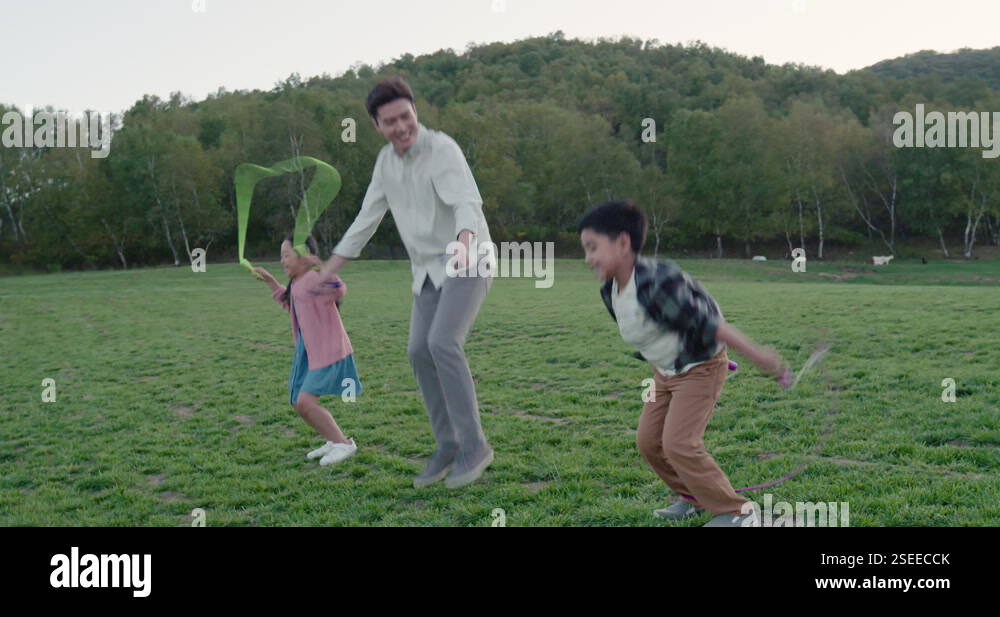 Happy young Chinese family jumping ropes outdoors,4K Stock Video ...