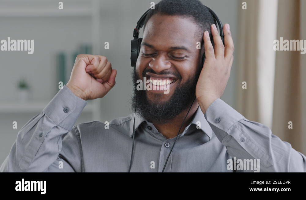 Distracted from office work sincere happy young African American ...