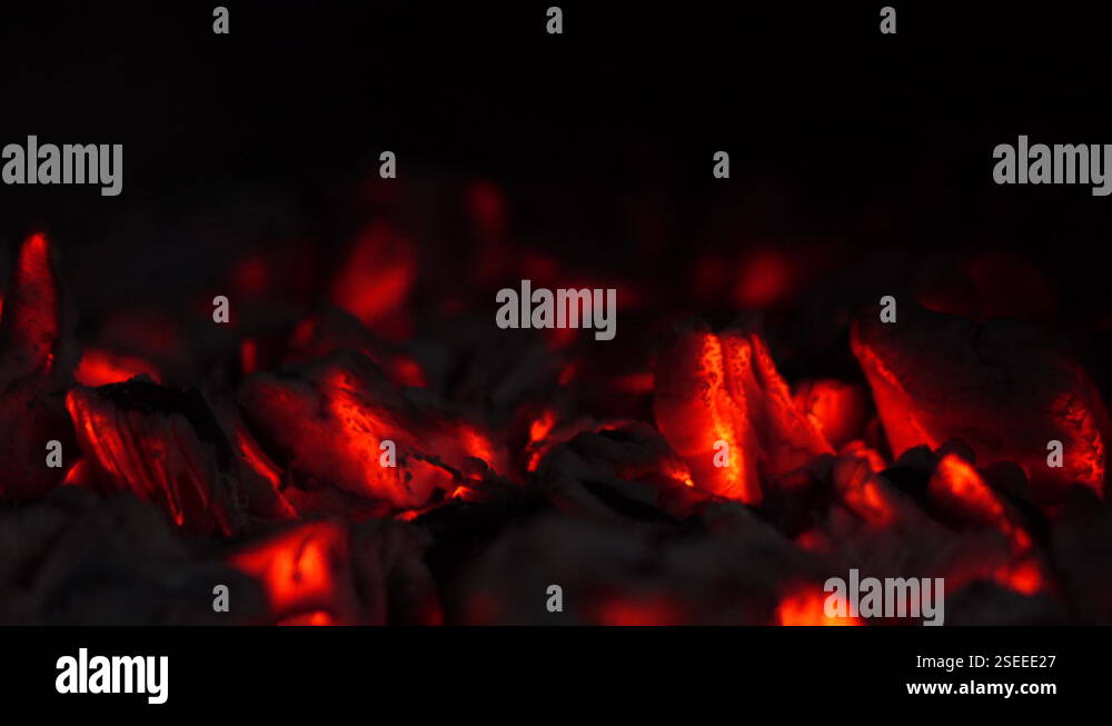Smoldering embers .The burning texture of red charcoal in a barbecue ...