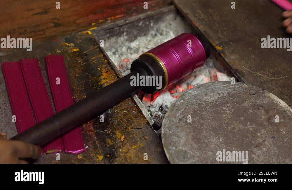 Indian craftsman making beautiful handmade lac bangles in a traditional ...