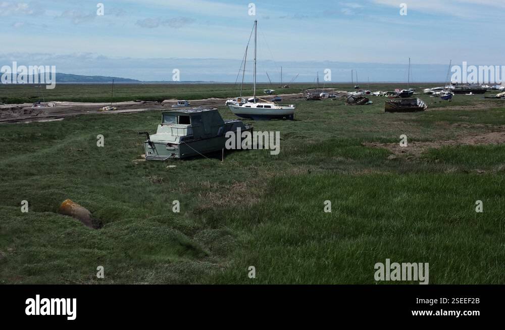 Abandoned old fishing boat carcass shipwreck in shipyard low tide mud ...