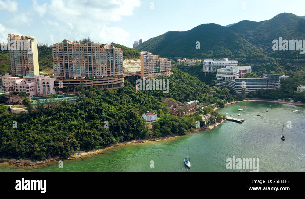 Aerial footage of Tai Tam Tuk, coast side building and mountain view ...
