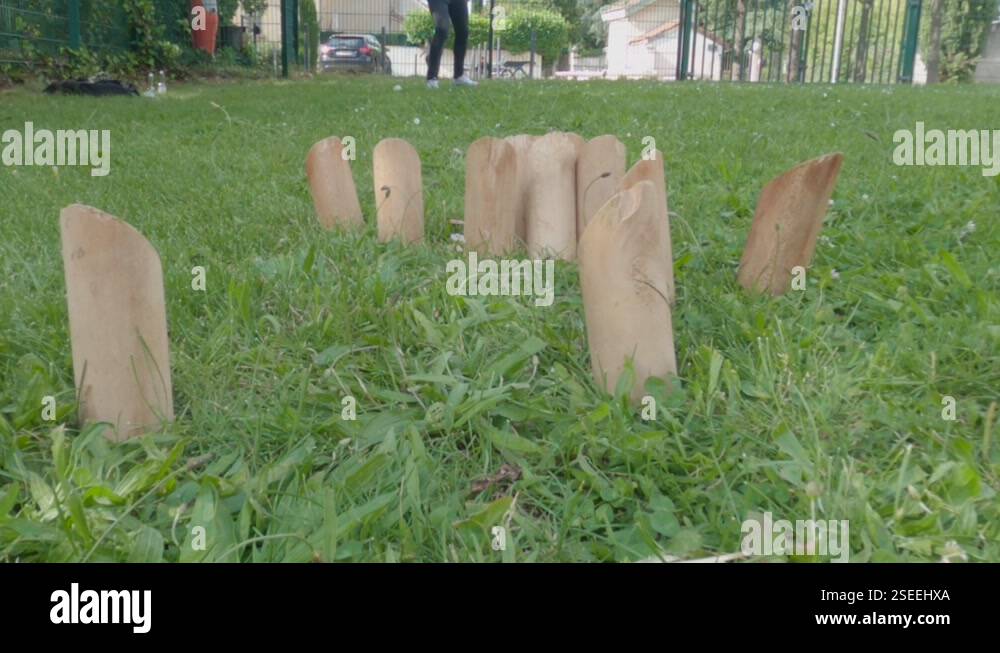Man Hits Numbered Skittles On The Grass With A Wooden Throwing Pin ...