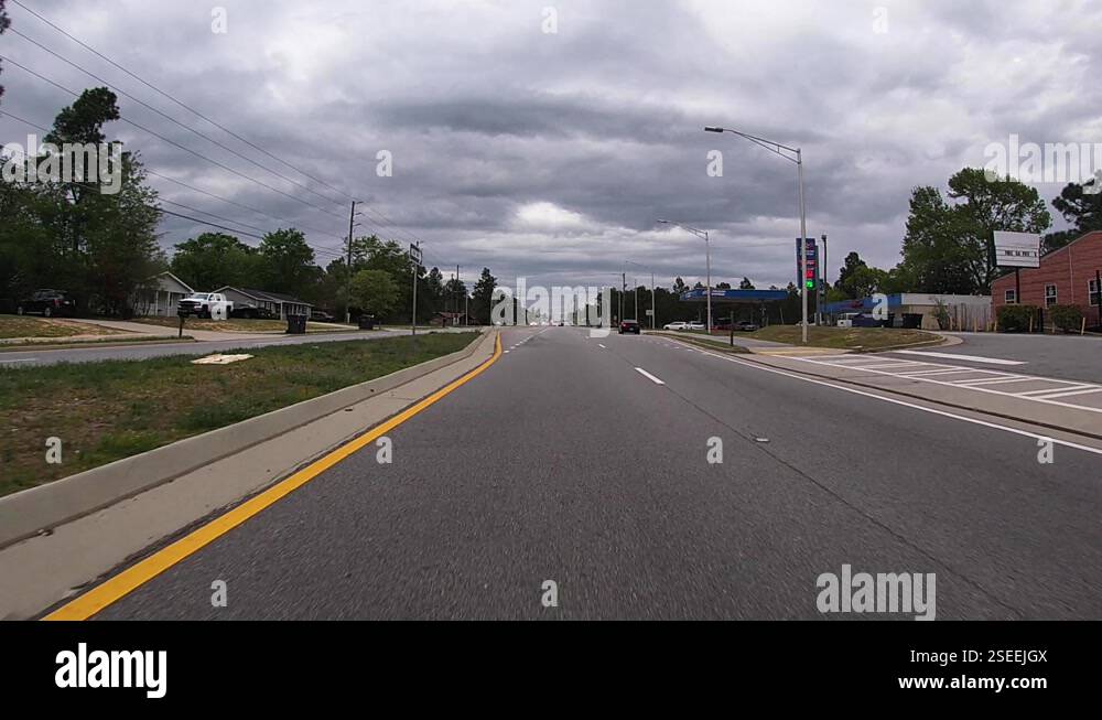 POV FPV driving on a newly designed road passing a gas station gas ...
