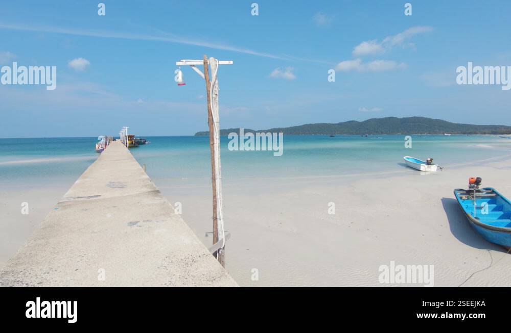 Walkway reaching into the crystal clear water of the bay in Koh Rong ...