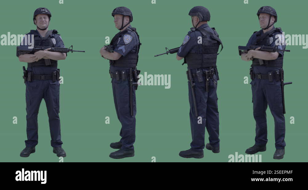 Armed Caucasian police officer standing and talking against green ...