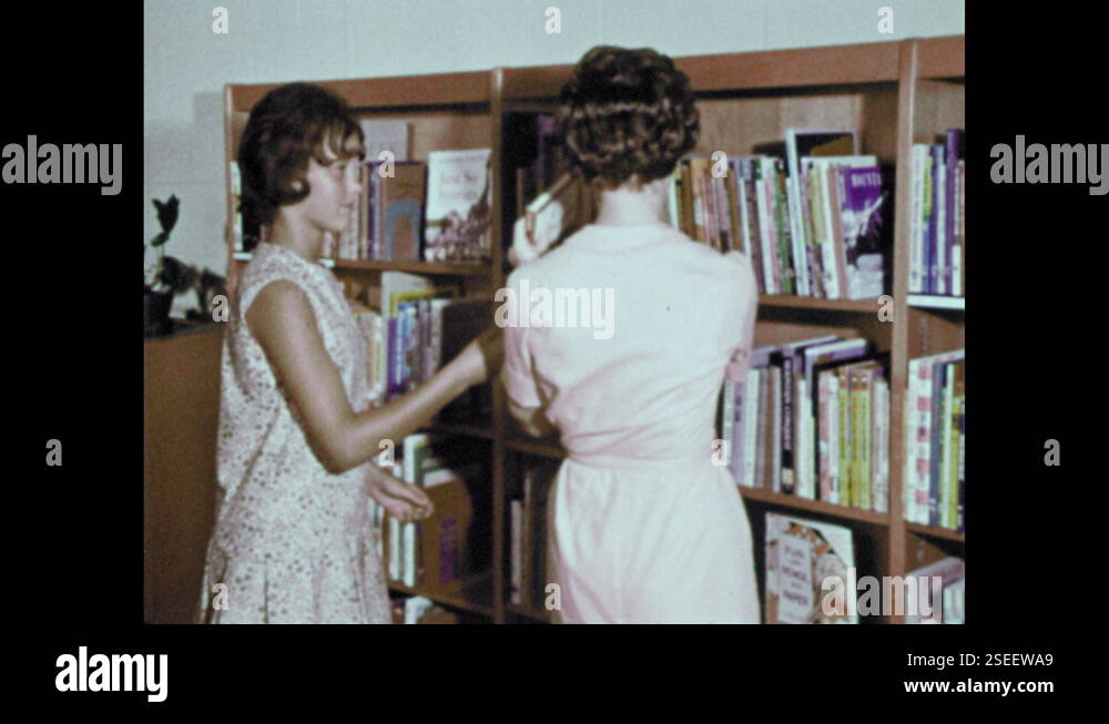 1950s: Librarian moves books from one shelf to another to make room ...