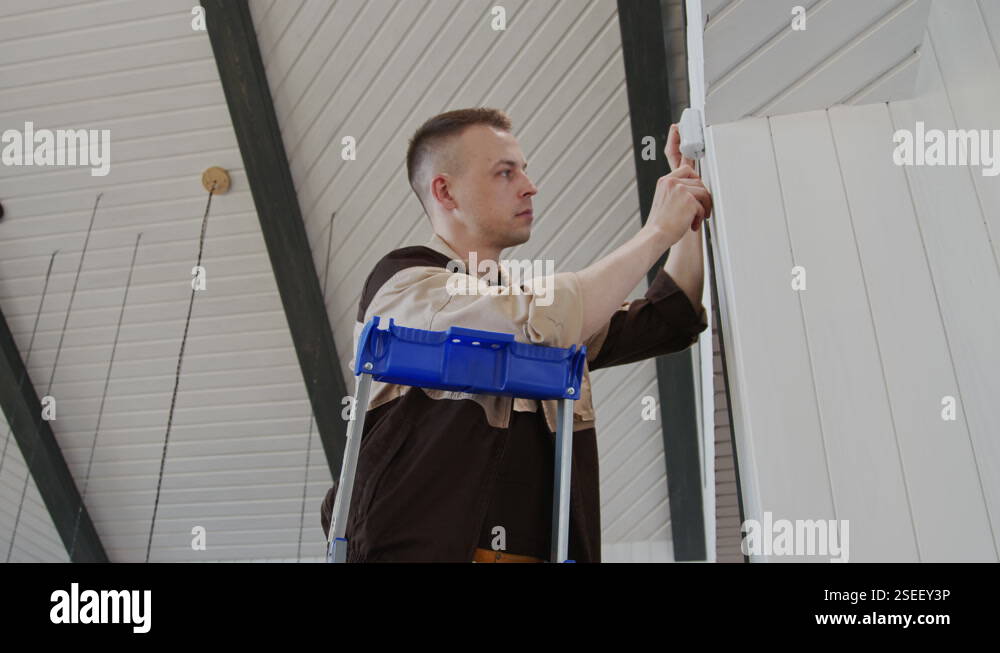 Handyman Installing Device or Sensor in House Stock Video Footage - Alamy