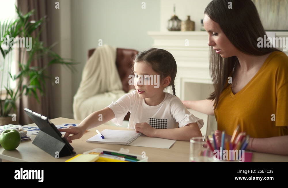 Girl make homework using tablet online with mother helping Spbd. Primary school Stock Video ...