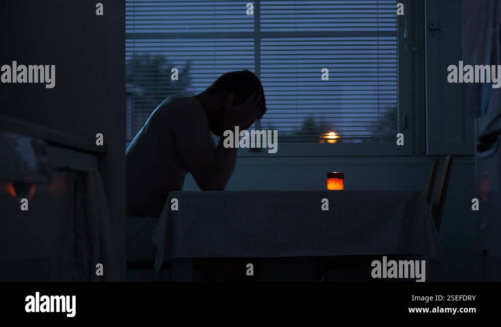 sad crying man recieves message of bad news in dark home at night Stock ...