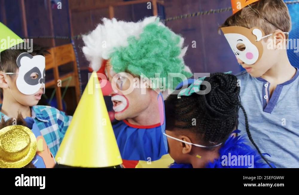 Animation of confetti falling over clown and children having fun at ...