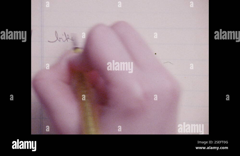 1970s: Girl writes on clipboard. Girl erases Stock Video Footage - Alamy