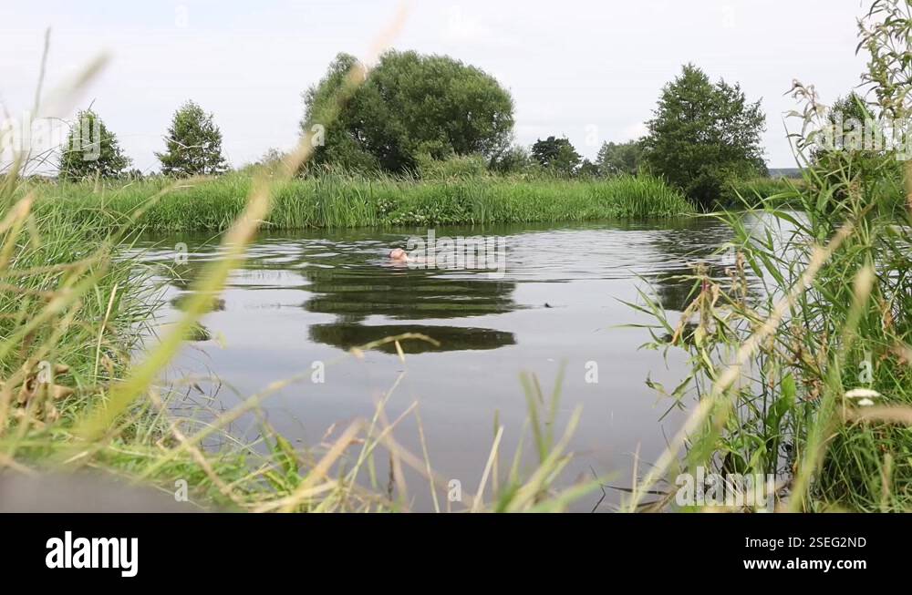 man bathes in a freshwater river in summer Stock Video Footage - Alamy