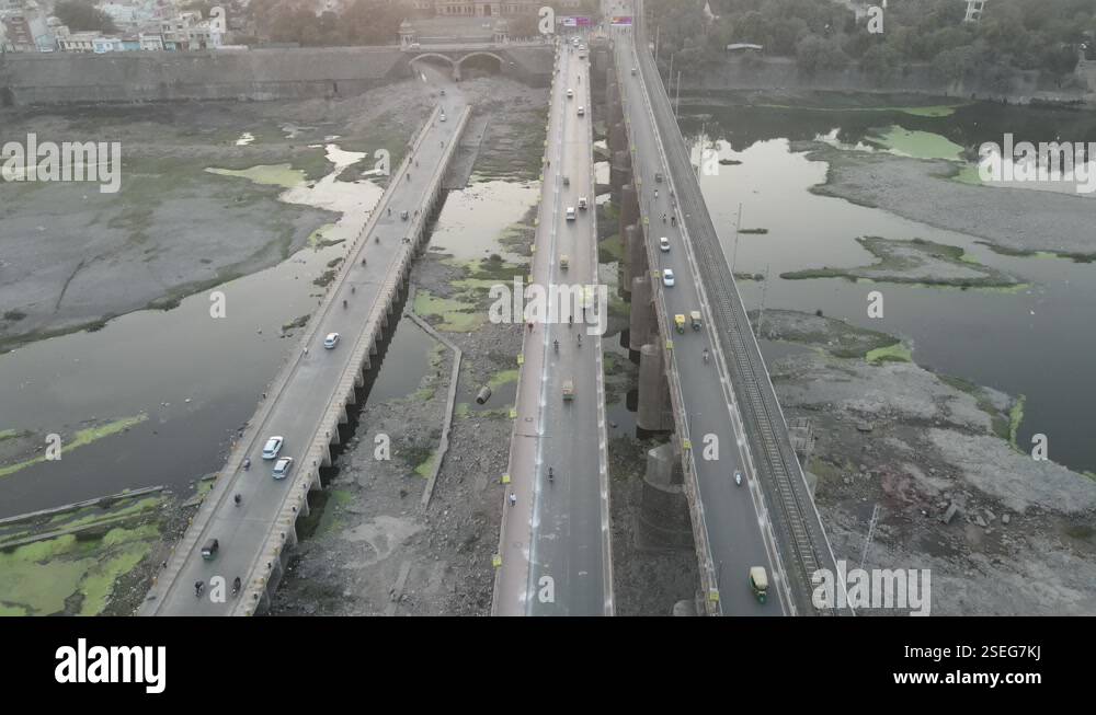 vehicles driving onto Bridge towards City Skyline , Aerial birds eye view Stock Video Footage ...
