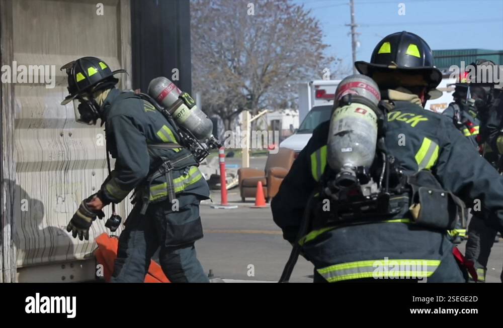 60fps firefighter dragging hose at emergency safety training putting ...