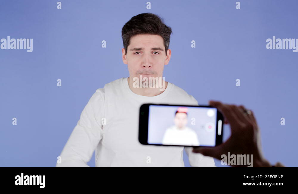 Smiling vlogger man recording video of hisself dancing in front of ...