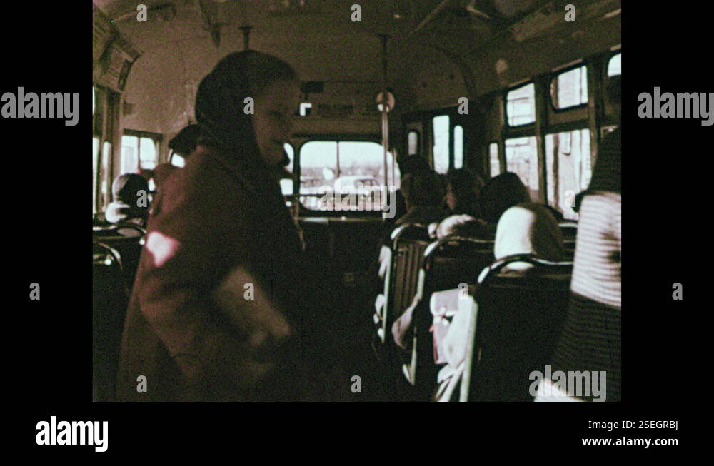 1950s: Children boarding school bus. Boy with his foot on seat. Foot ...