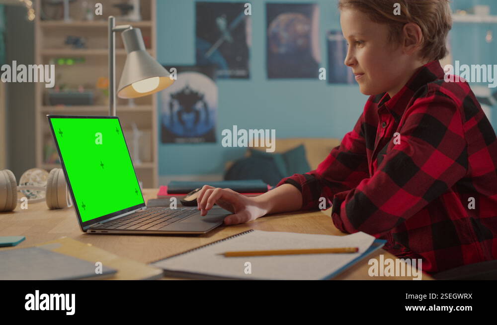 Young Boy Using Laptop Computer with Green Screen at Home Stock Video ...
