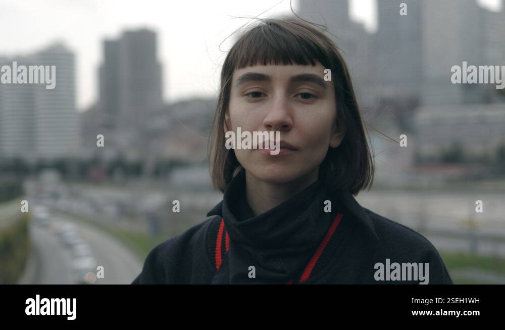 Portrait of woman with trendy haircut posing on city street Stock Video ...