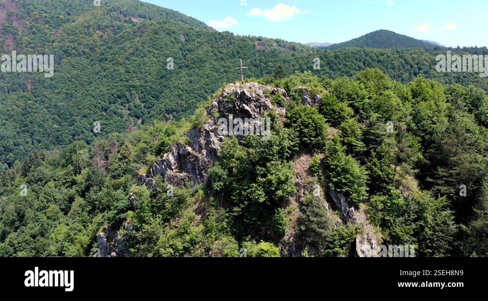 Summit Cross At The Rocky Cliff And Green Forest Covered The Mountain ...