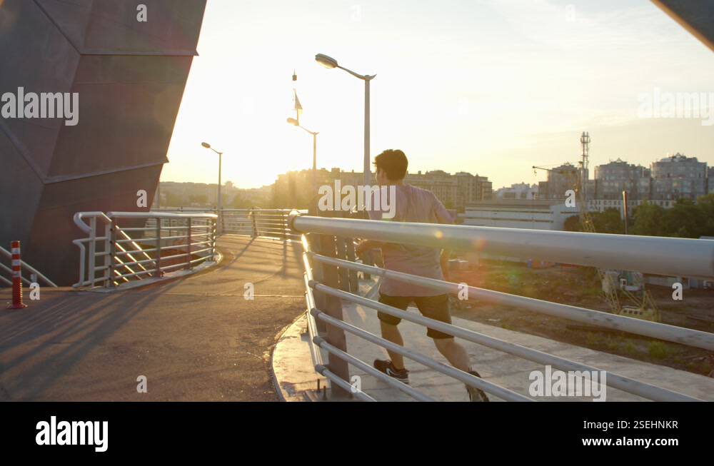 the guy runs across the bridge overcoming obstacles and tumbling around ...