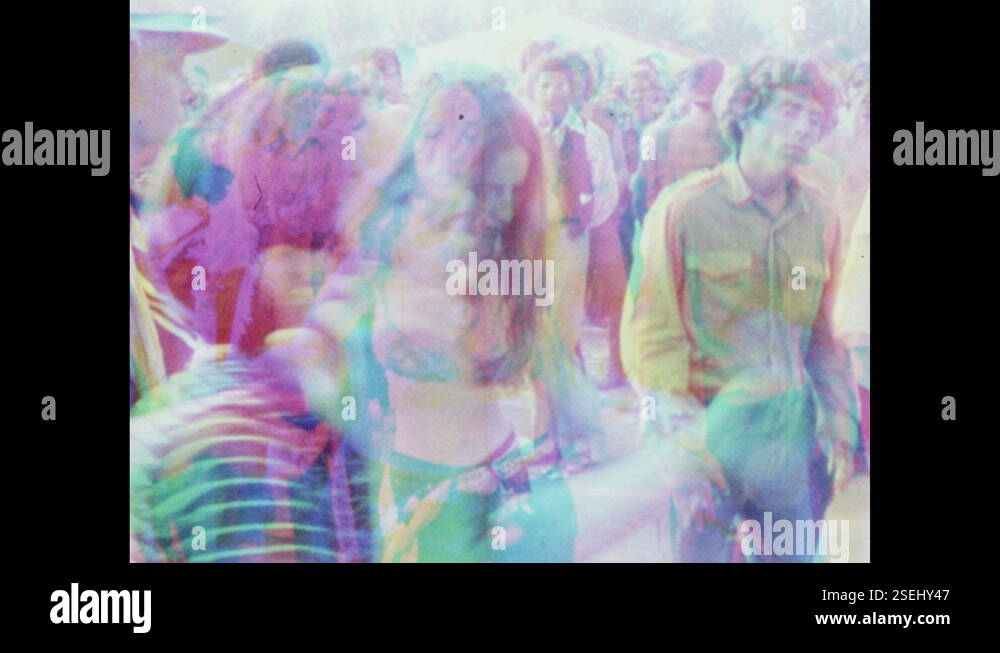 1960s: Multicolor tinted people dancing in place. Woman in bikini top ...