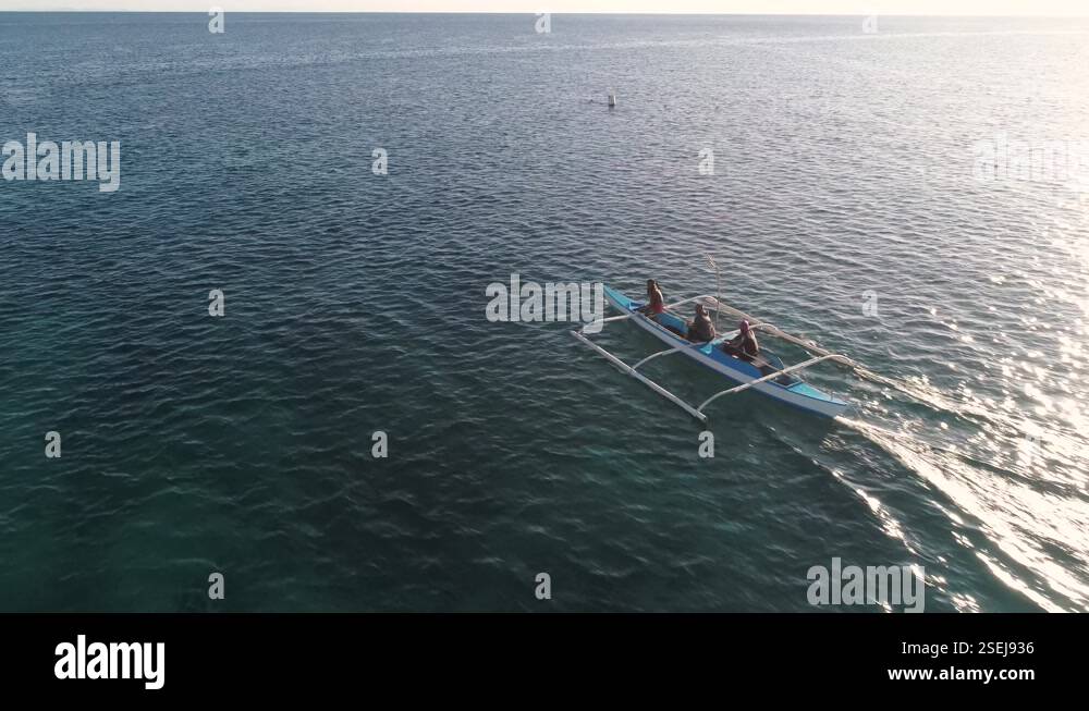 Local fisherman traveling on native double outrigger boat in sea ...
