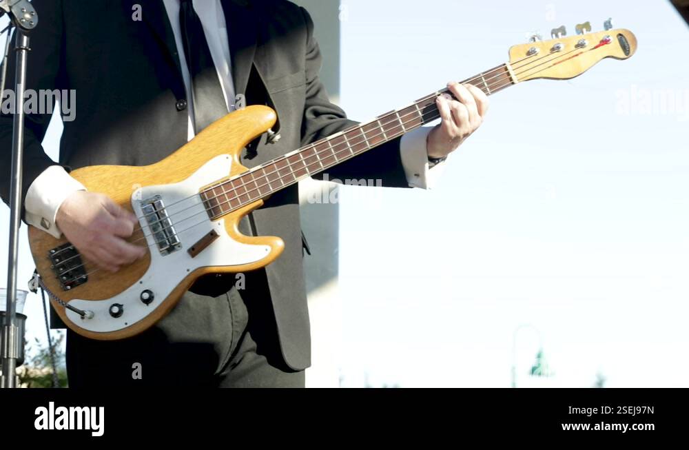 Man Playing Bass Guitar On Stage Of Open Air Concert During Summer ...