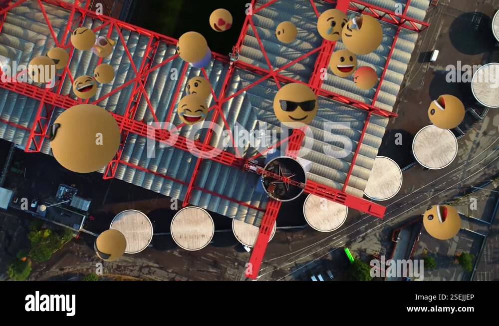 Digital composition of multiple face emojis floating against aerial ...