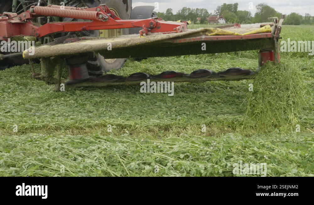 Slow Motion of Tractor With Mower Mowing Grass on Countryside Farm ...