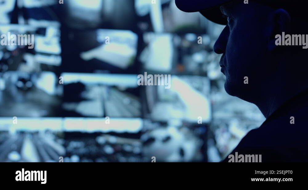 Male Officer Sits in a Control Room in front of a Surveillance CCTV ...