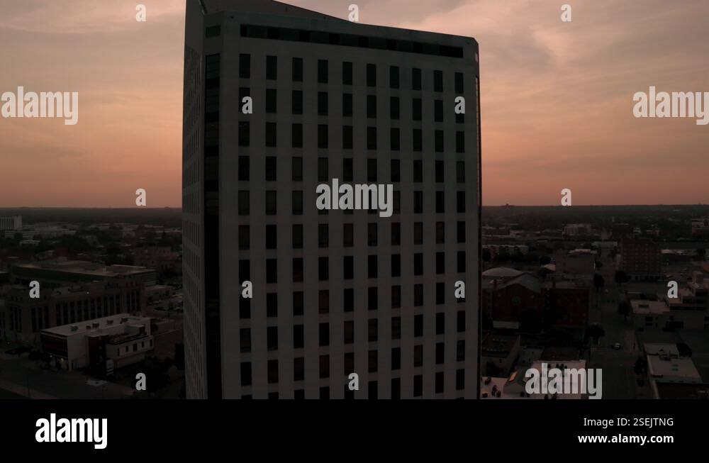 Drone reveal of downtown Wichita Kansas cityscape during warm sunrise ...