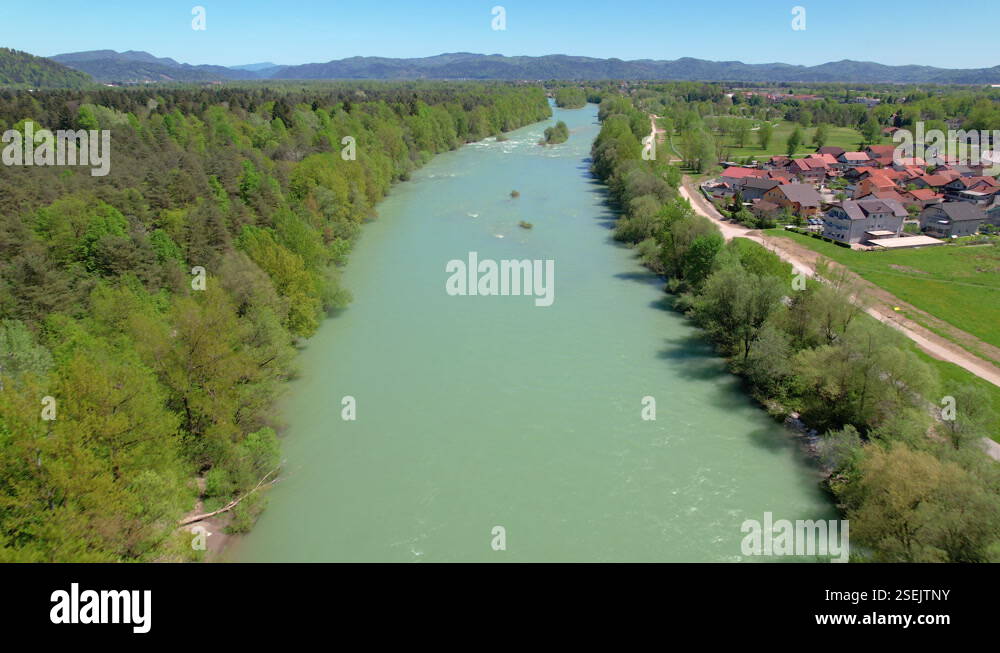 AERIAL: Flying along the emerald river coursing through the green ...