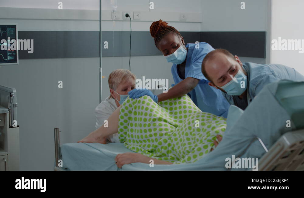 Young woman pushing while giving birth to child in hospital ward Stock ...