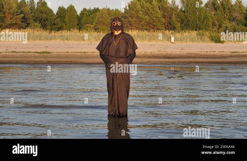 Cinematic blurred environment. The monk in a black suit crossed the sea ...