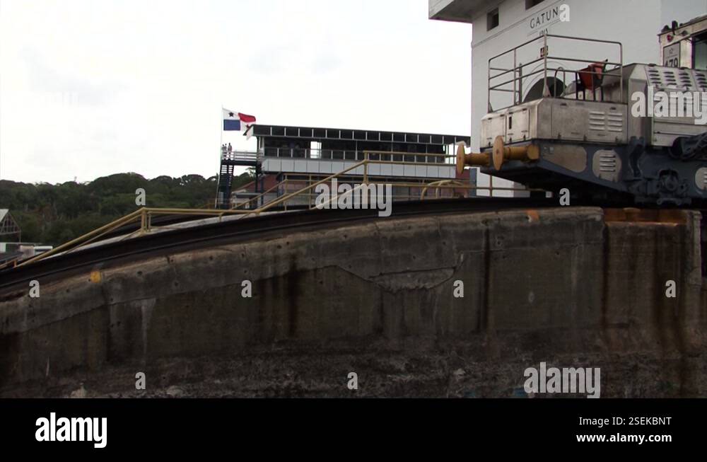 Gatun Locks traffic control tower, electric locomotive and flag of ...